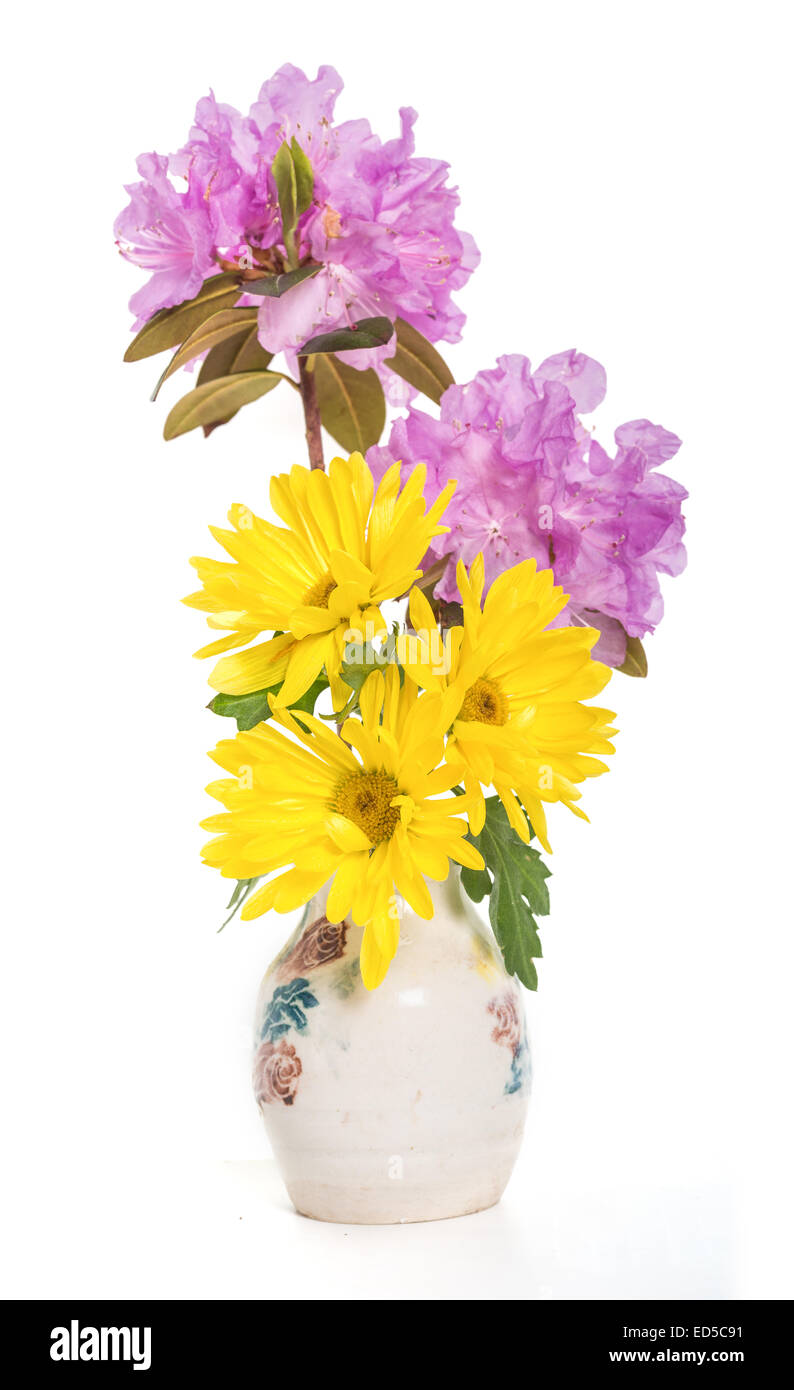 A spring bouquet of yellow mums and lavender PJM rhodoendrons in a ...