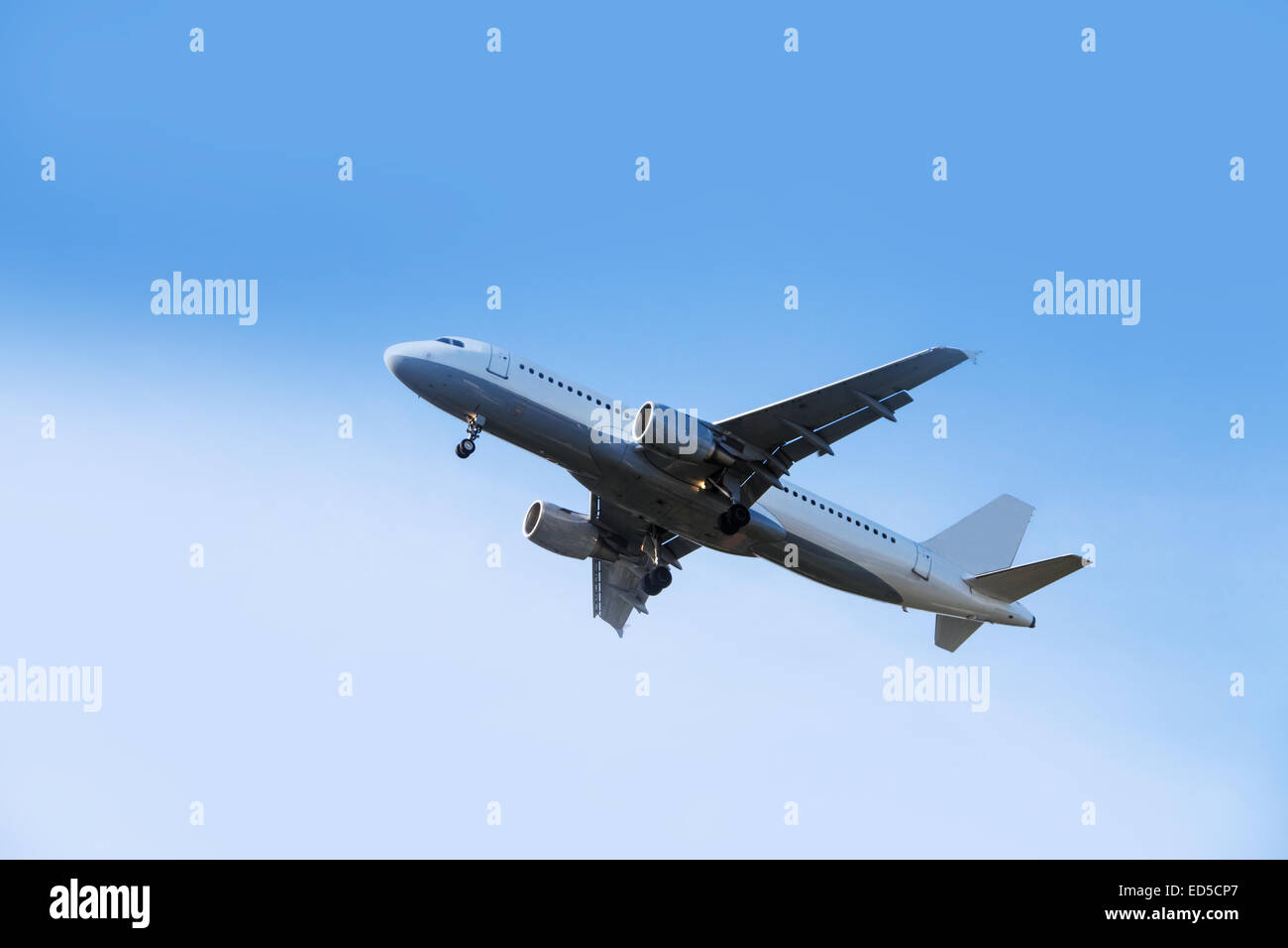 rising airplane in blue sky Stock Photo - Alamy