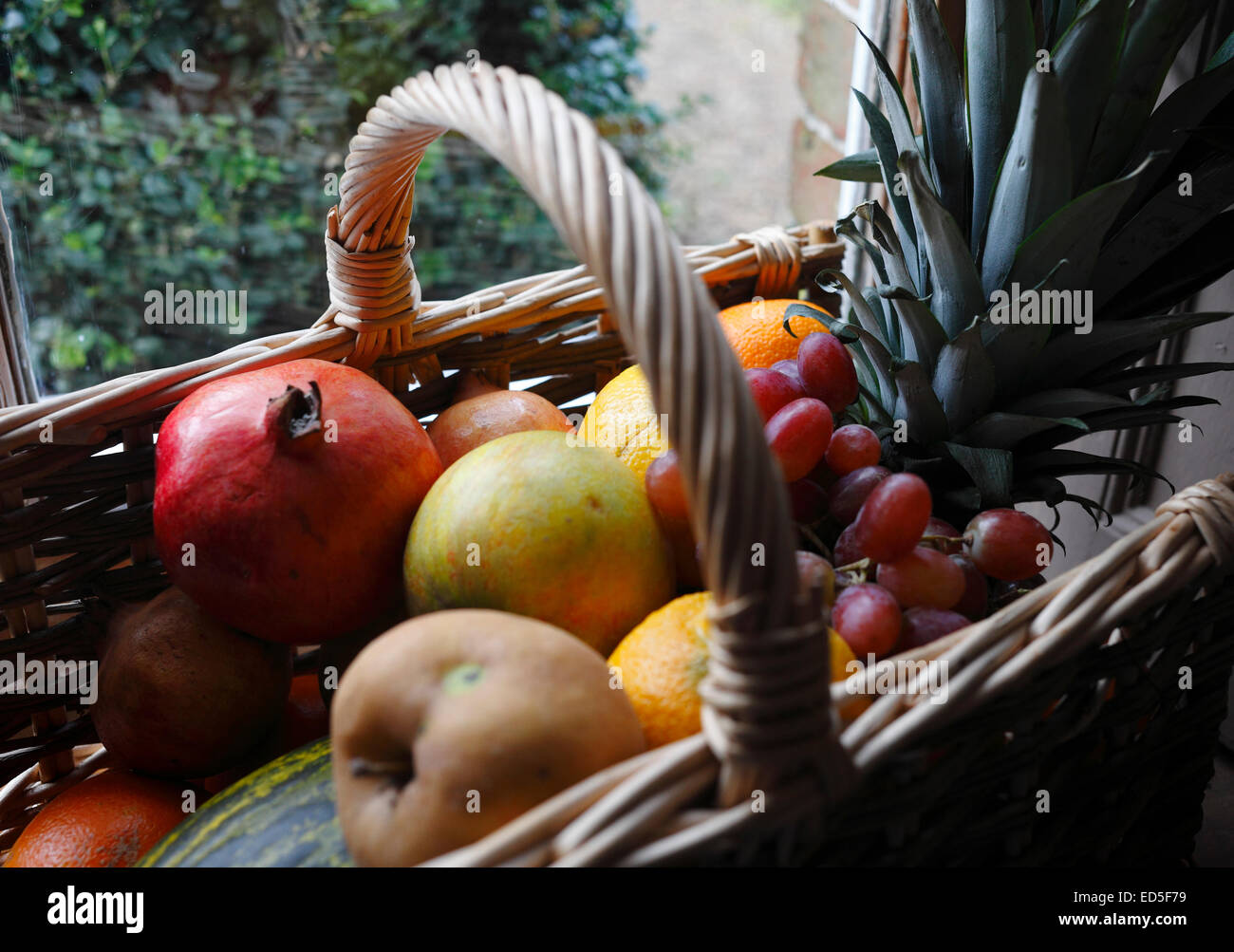 A selection of fruit in a basket by a window Stock Photo - Alamy