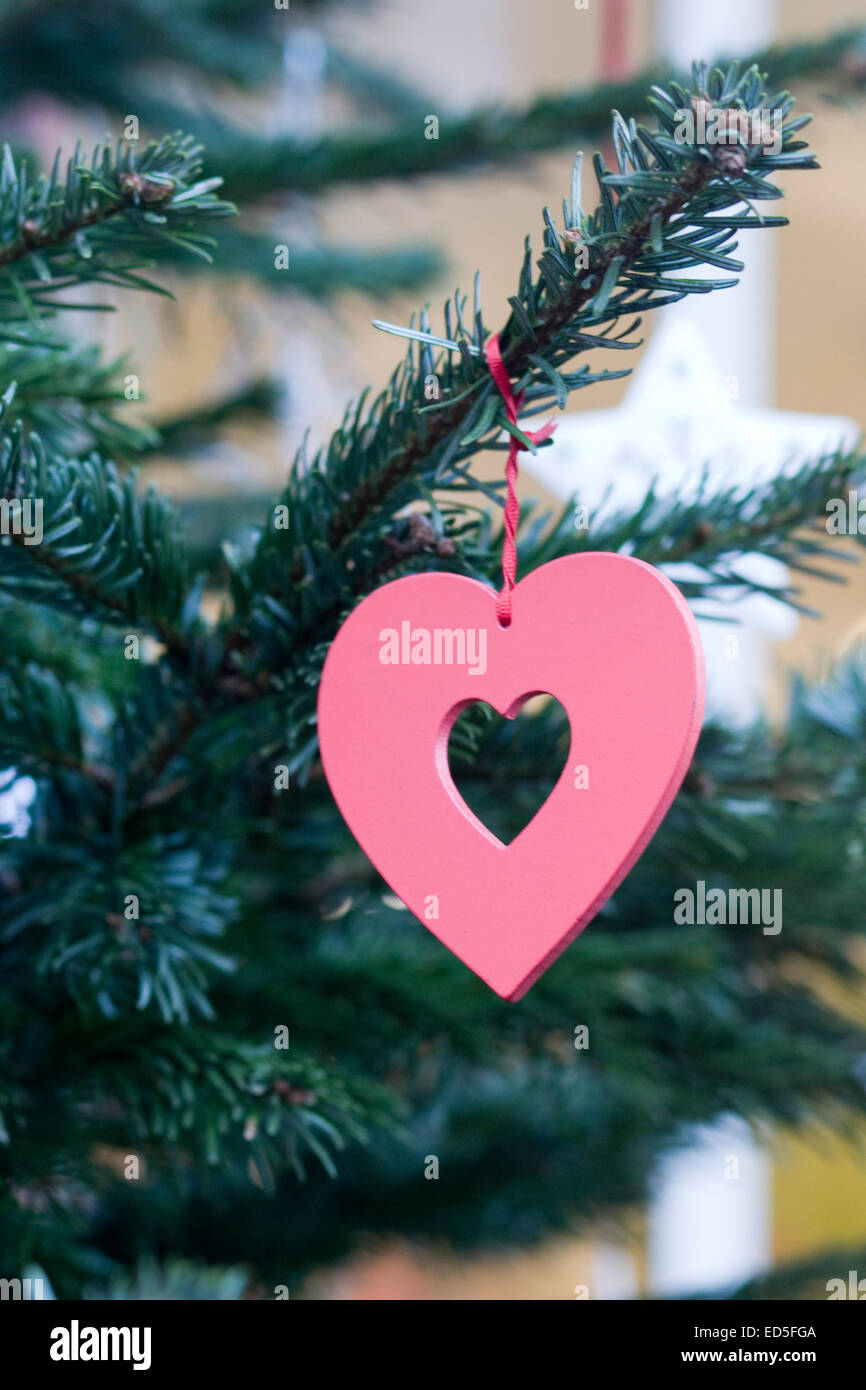 wooden heart Christmas Decorations on a Christmas Tree Stock Photo - Alamy