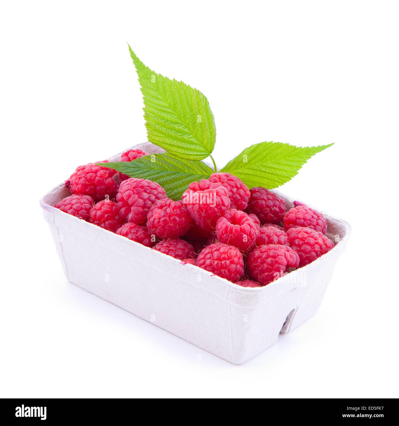 Fresh raspberries in a paper punnet isolated on white Stock Photo - Alamy