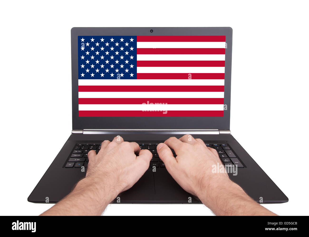 Hands working on laptop showing on the screen the flag of the USA Stock ...
