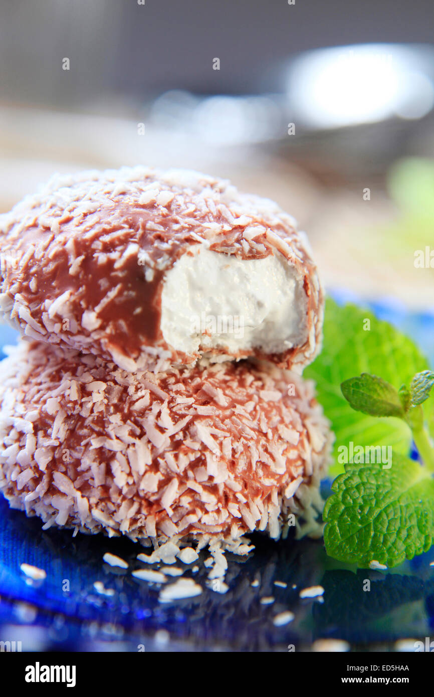 Chocolate coconut confections filled with cream Stock Photo - Alamy