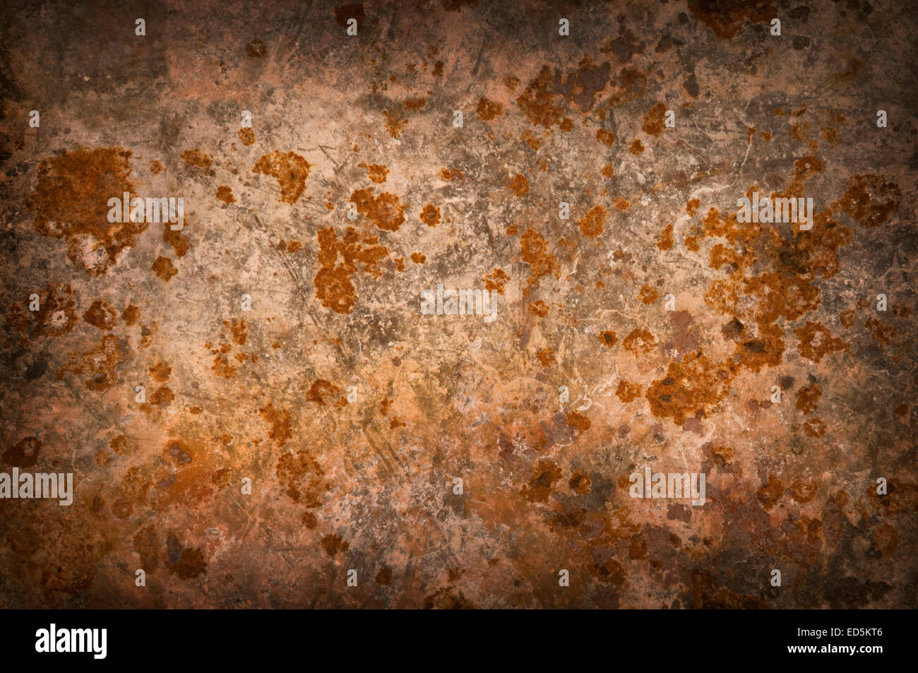 Metallic background with rusty corrosion, darkened around the edges ...