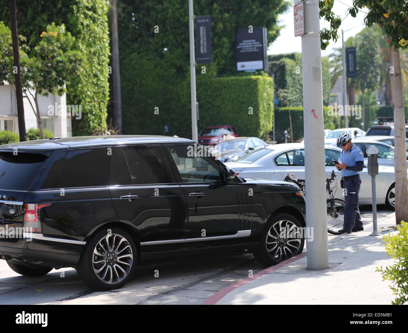 Sharon Osbourne walks to her car with her Pomeranian pet dog after ...