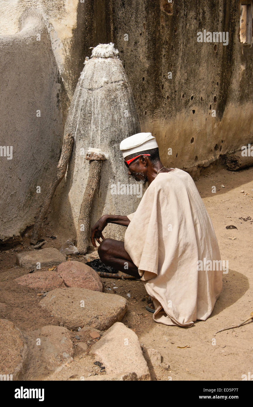 Village priest of the Talensi tribe worshiping at ancestor shrine ...