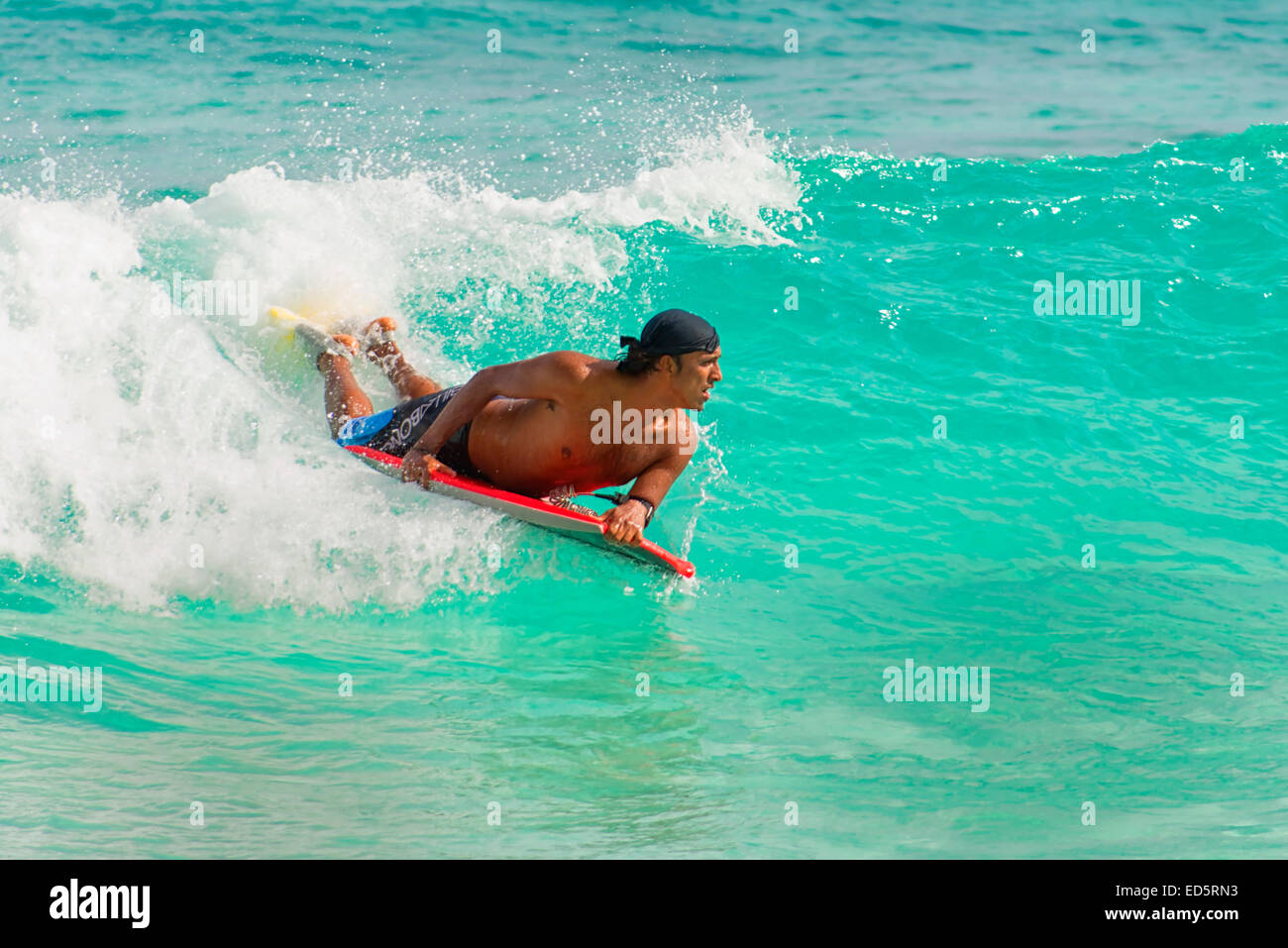 Surfer at Grand Anse Beach in La Digue, Seychelles Stock Photo - Alamy