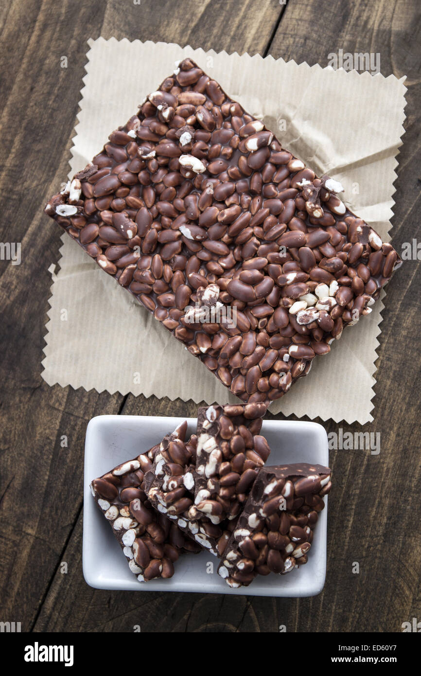 chocolate with puffed rice bar on wooden table,from above Stock Photo ...
