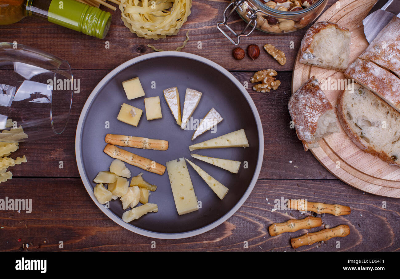 elegant appetizer with white wine different cheeses, bread and pasta on ...