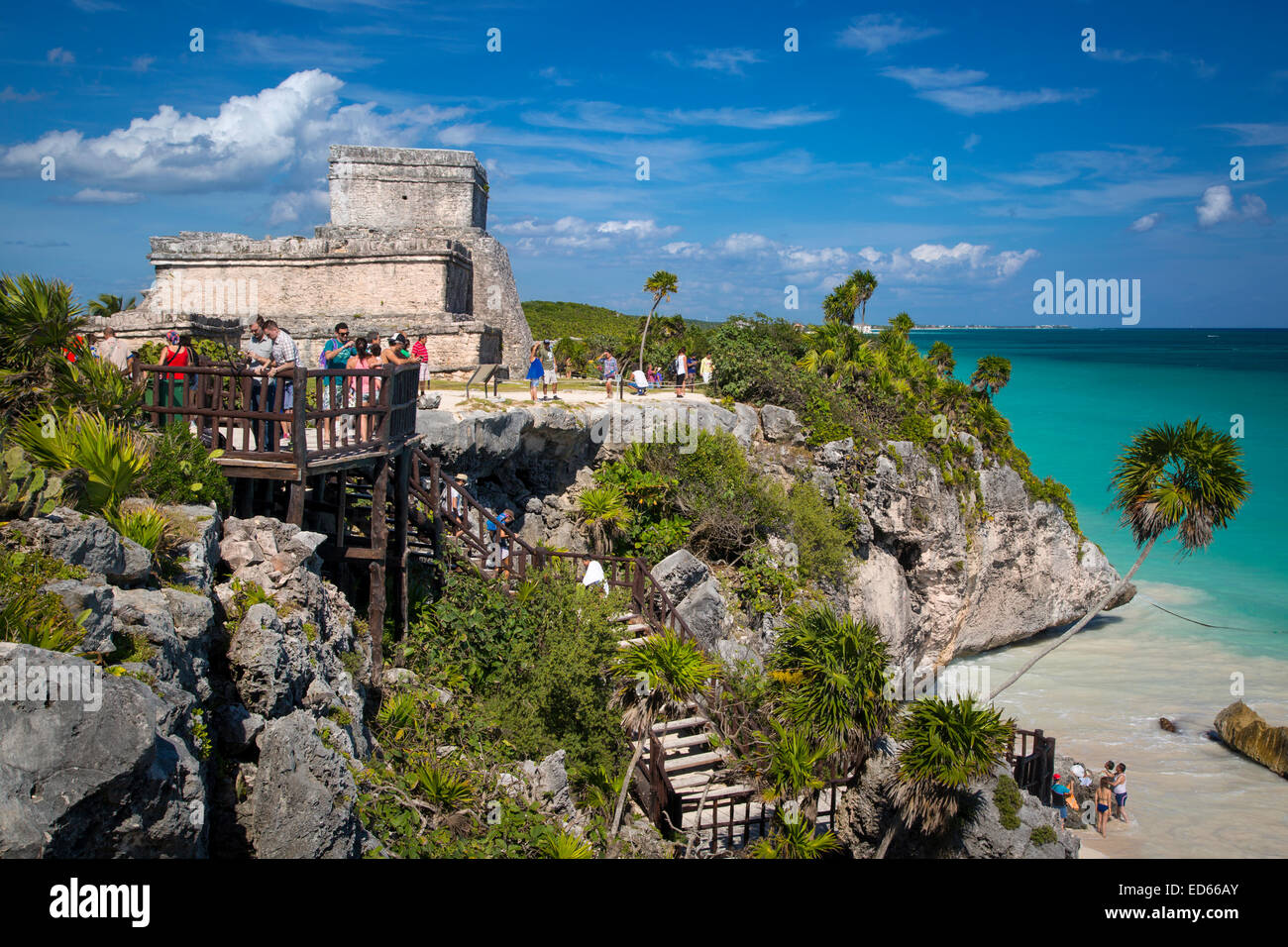 Tourists visiting ruins of the Mayan temple grounds at Tulum, Quintana ...
