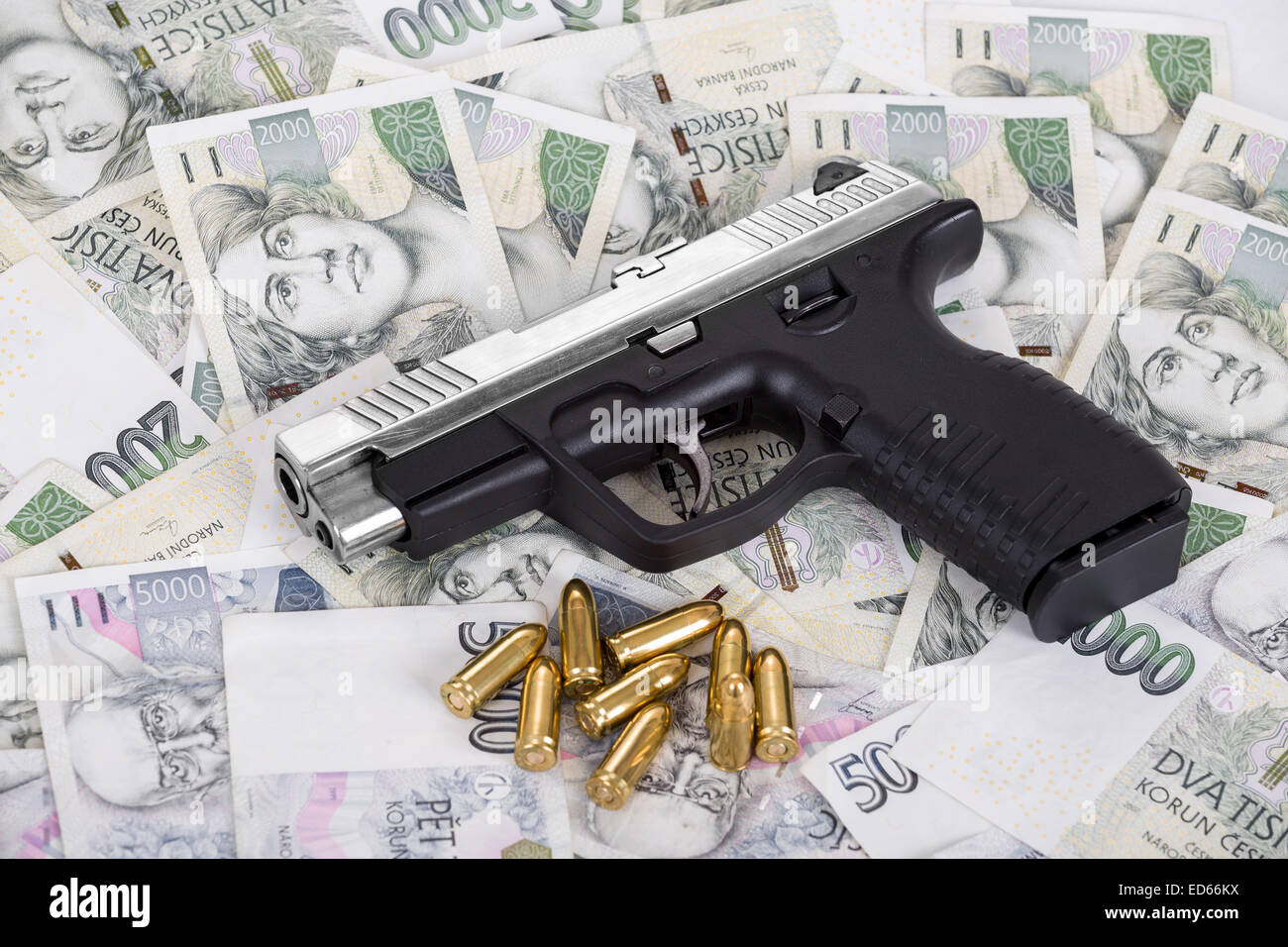 detail of gun with bullet on czech banknotes background Stock Photo - Alamy