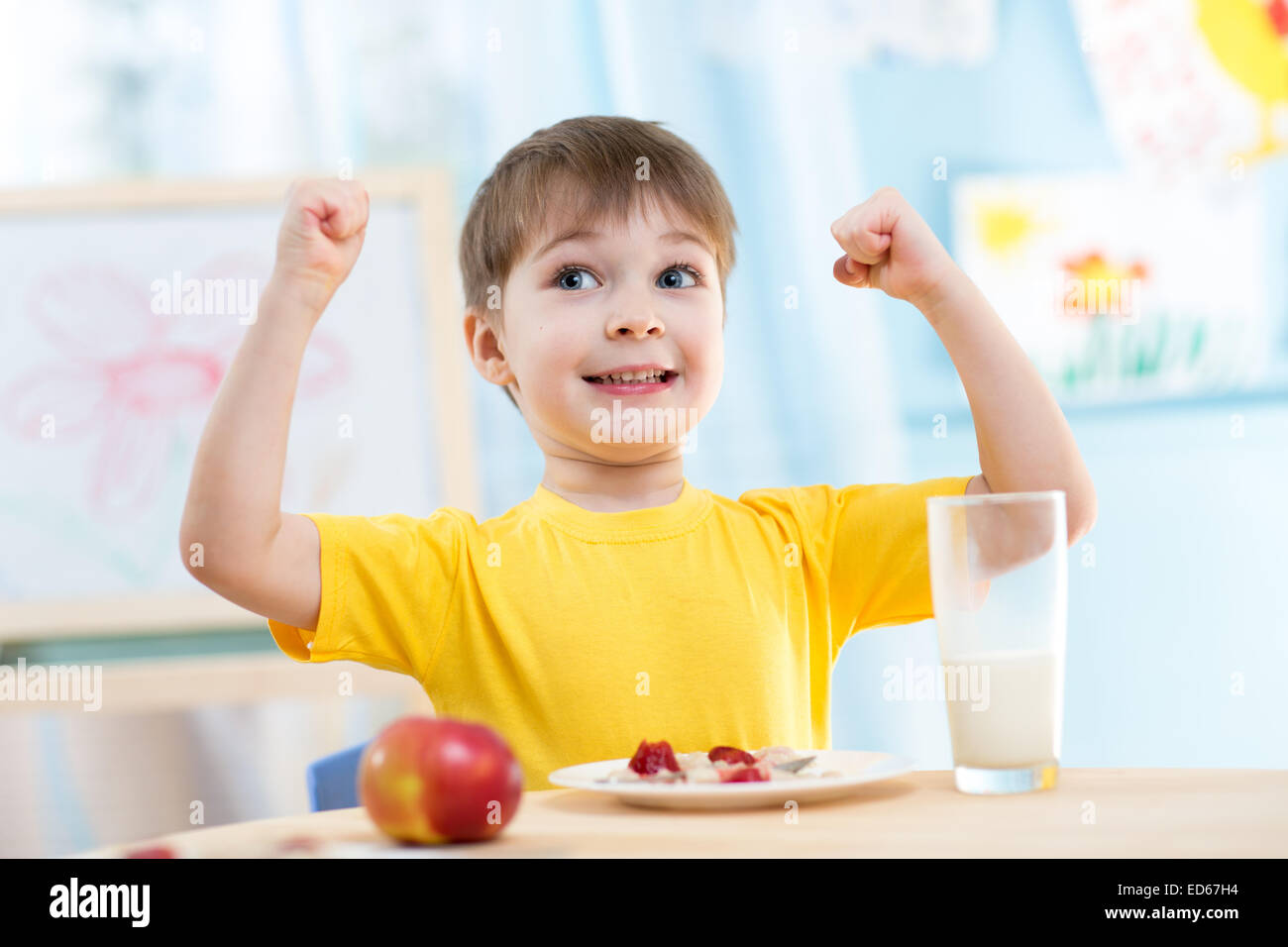 child boy eating healthy food and showing his strength Stock Photo - Alamy