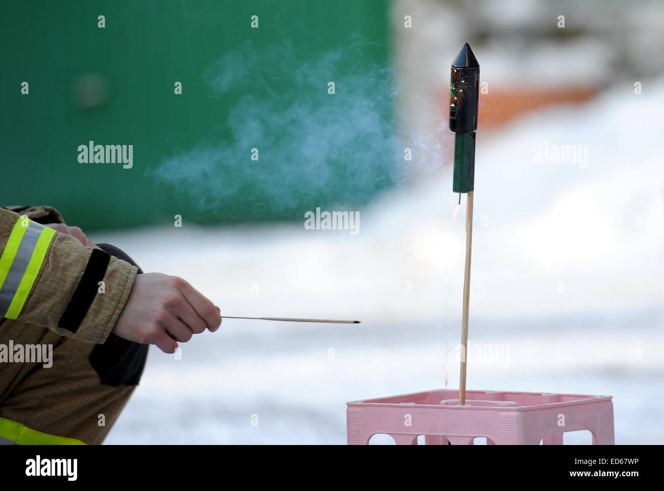 Berlin, Germany. 29th Dec, 2014. A pyrotechnician lights a rocket in ...