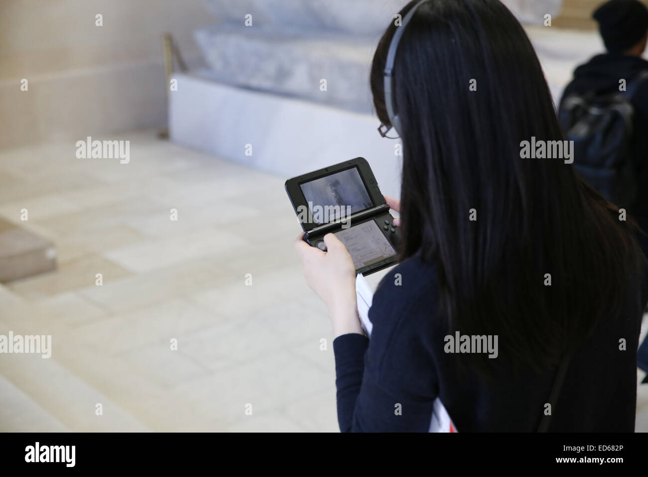 asian tourist using audio visual museum guide Stock Photo - Alamy