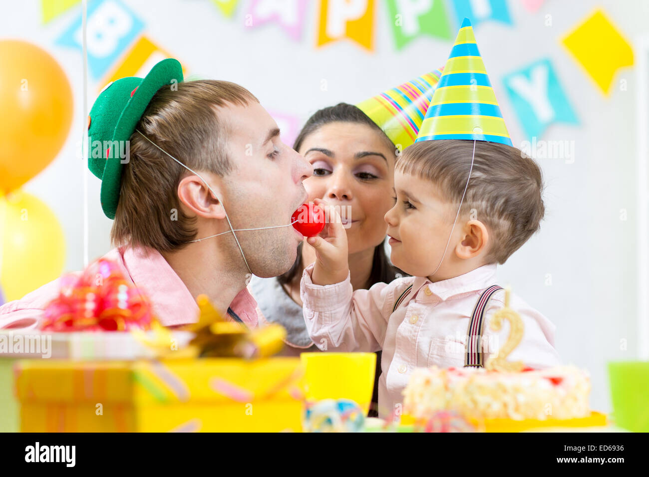 parents have fun celebrating birthday of kid son Stock Photo - Alamy
