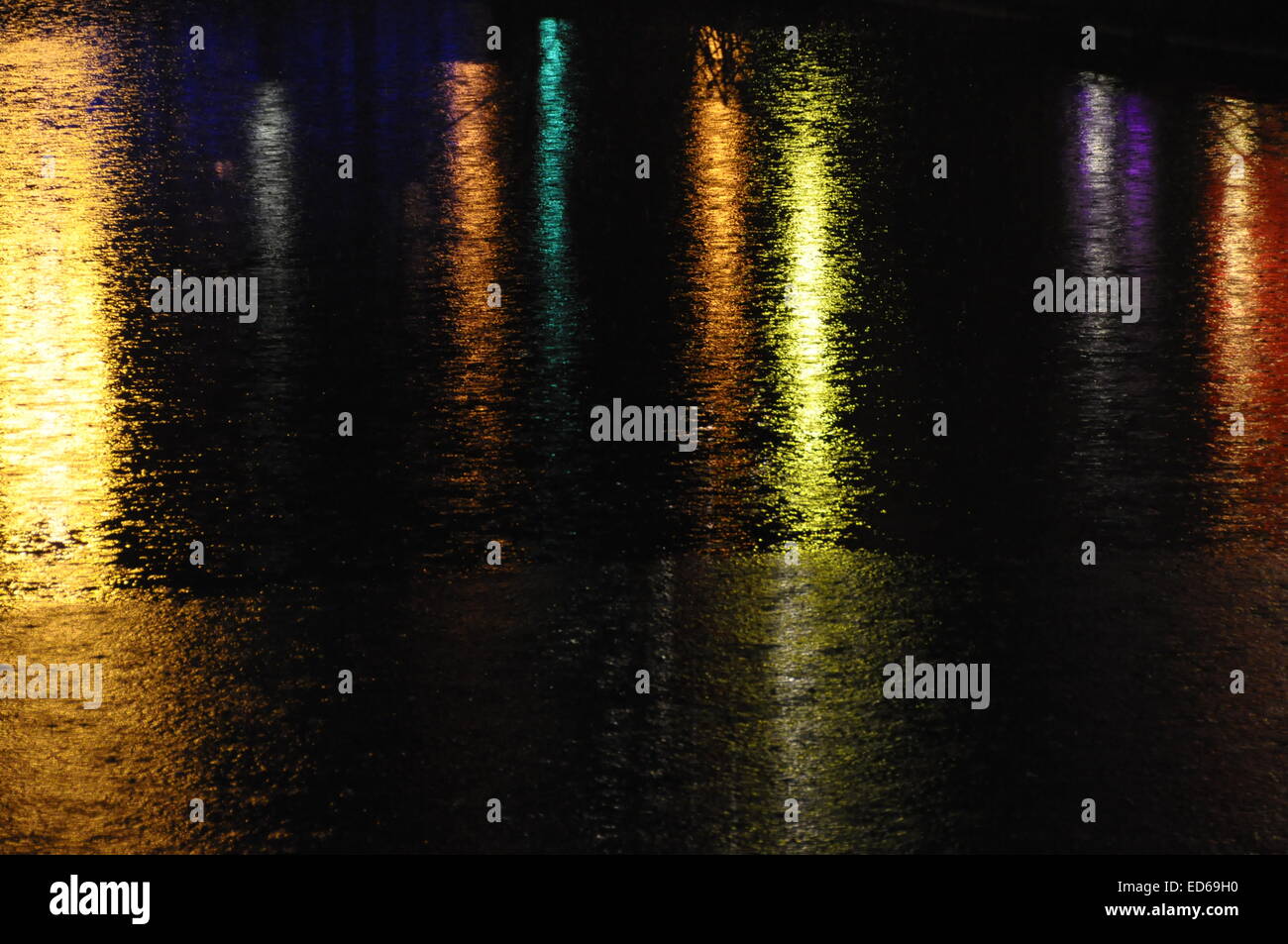 Reflection of Colored lights on water by night Stock Photo - Alamy