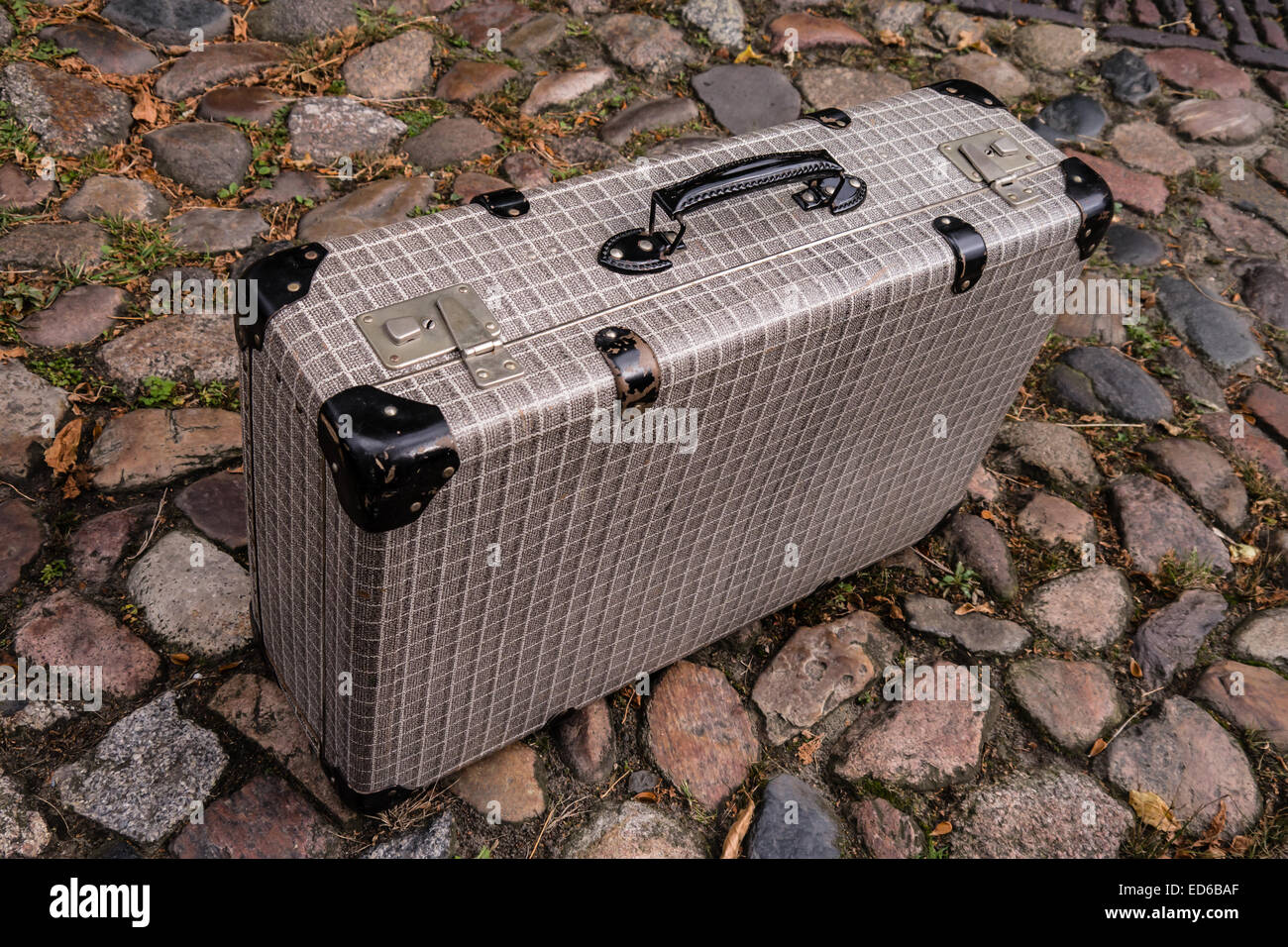 suitcase on cobble stone street Stock Photo - Alamy