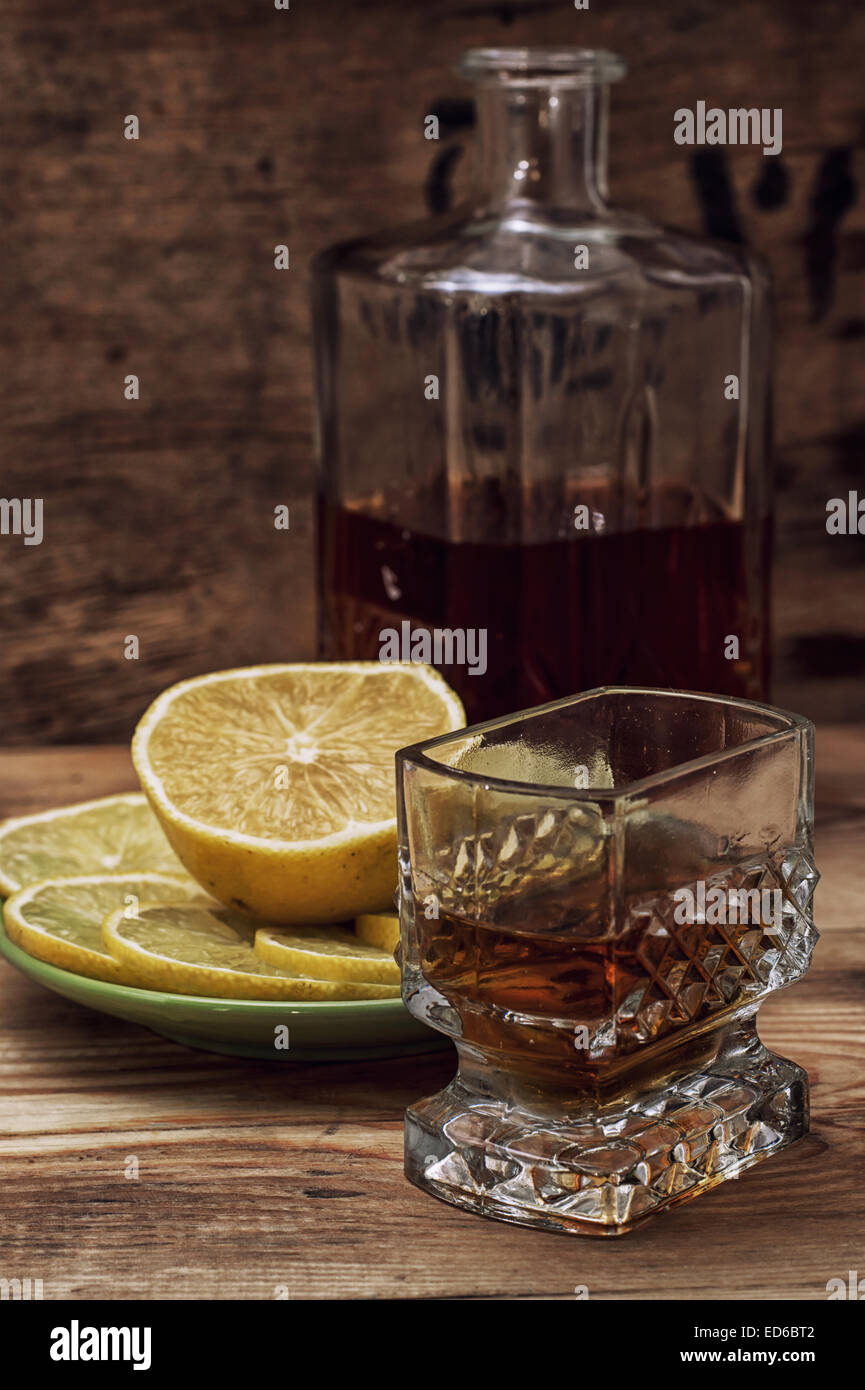 seasoned brandy into the glasses and decanter vintage style Stock Photo ...