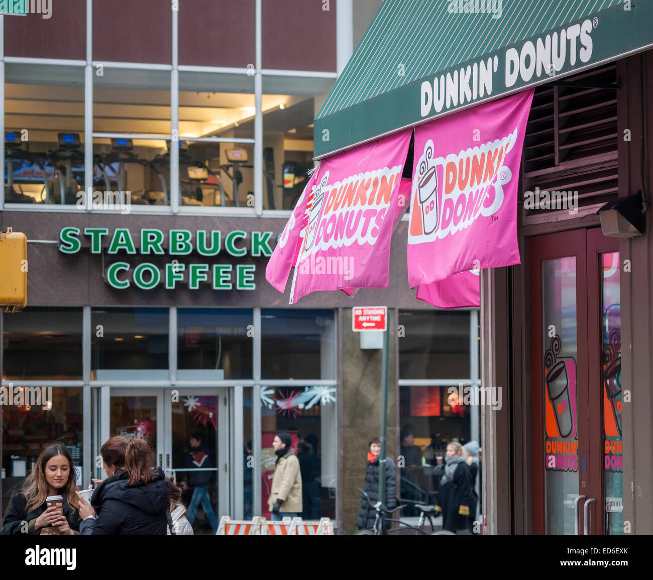 Competitors Starbucks and Dunkin' Donuts are seen on opposite street ...