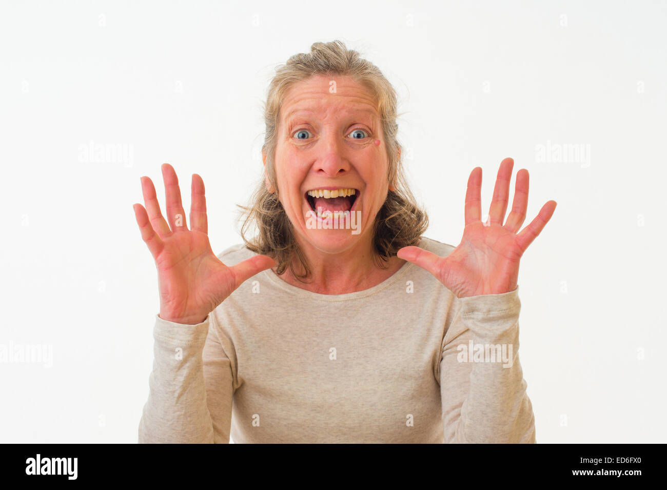 A happy ecstatic orty year old caucasian woman against a white ...