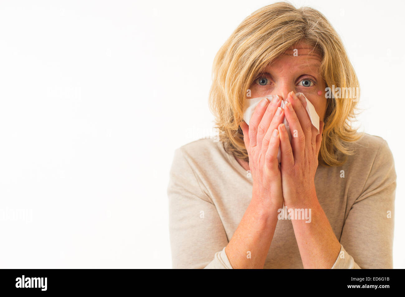 A forty year old caucasian adult woman suffering with a winter cold or ...