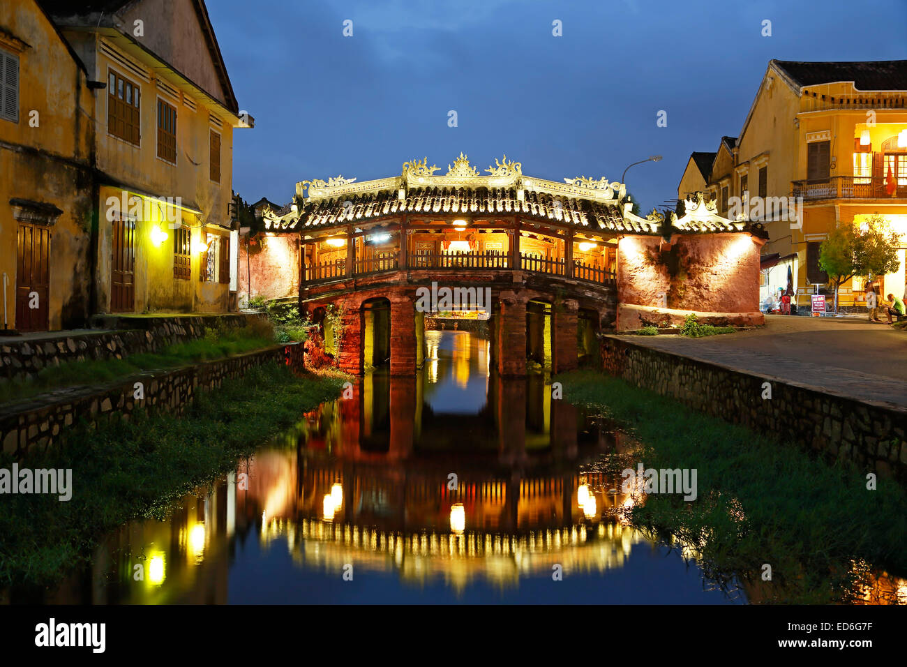 Japanese Covered Bridge reflected on canal, Hoi An, Vietnam Stock Photo ...