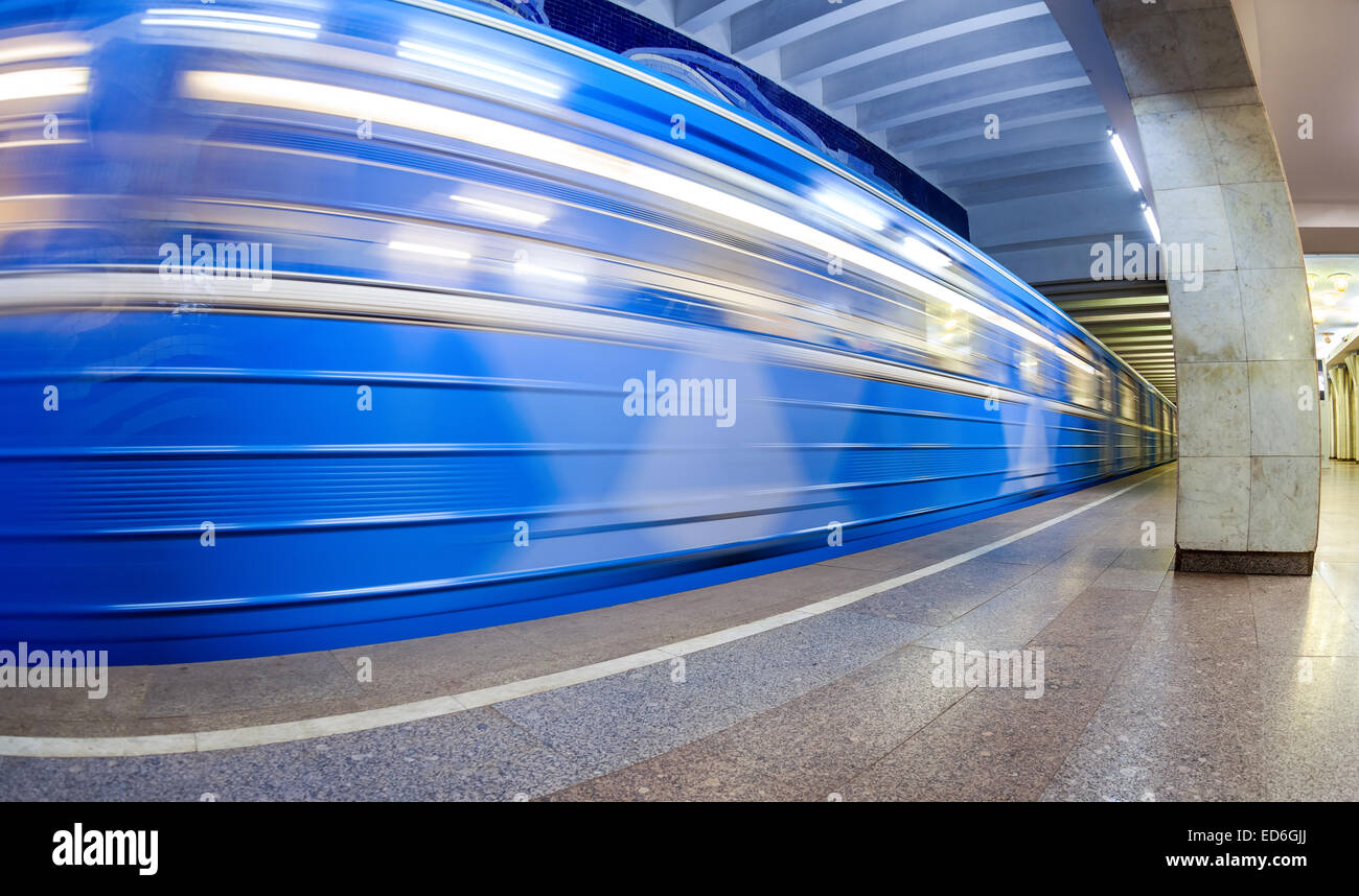 Blue subway train in motion at the underground station. Wide angle ...