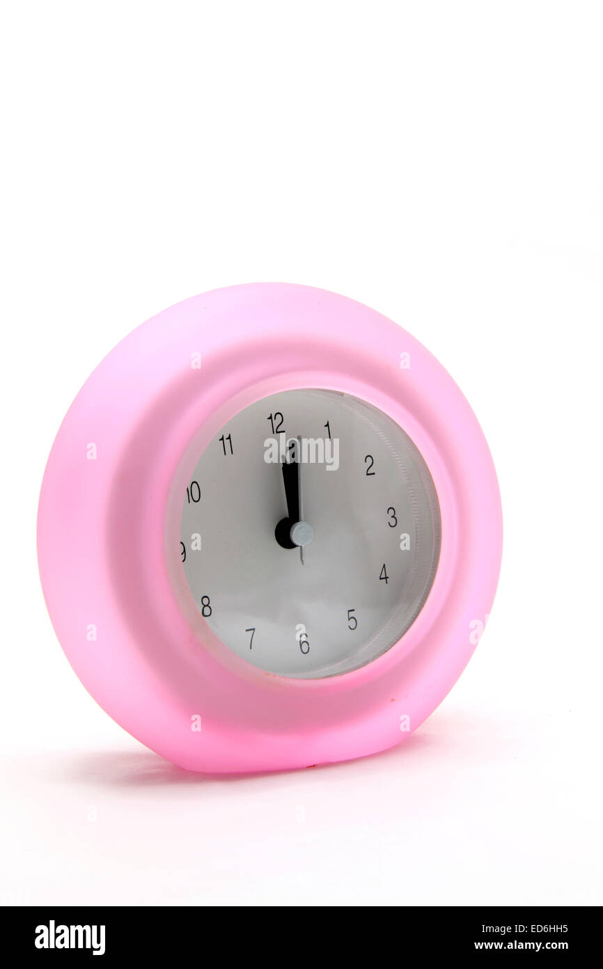 pink round modern alarm clock side perspective Stock Photo - Alamy