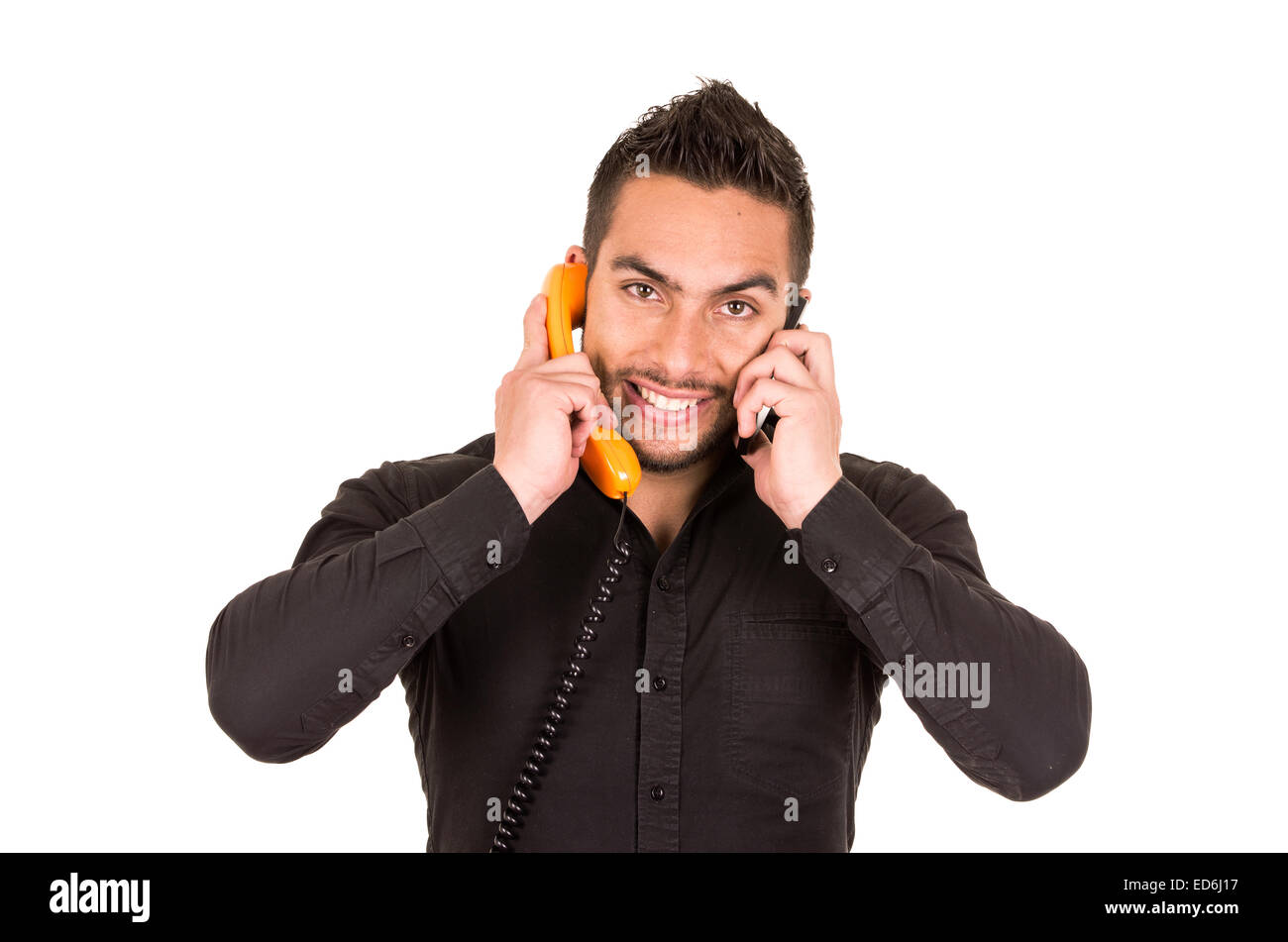 closeup shot of handsome man using corded telephone and cell phone ...