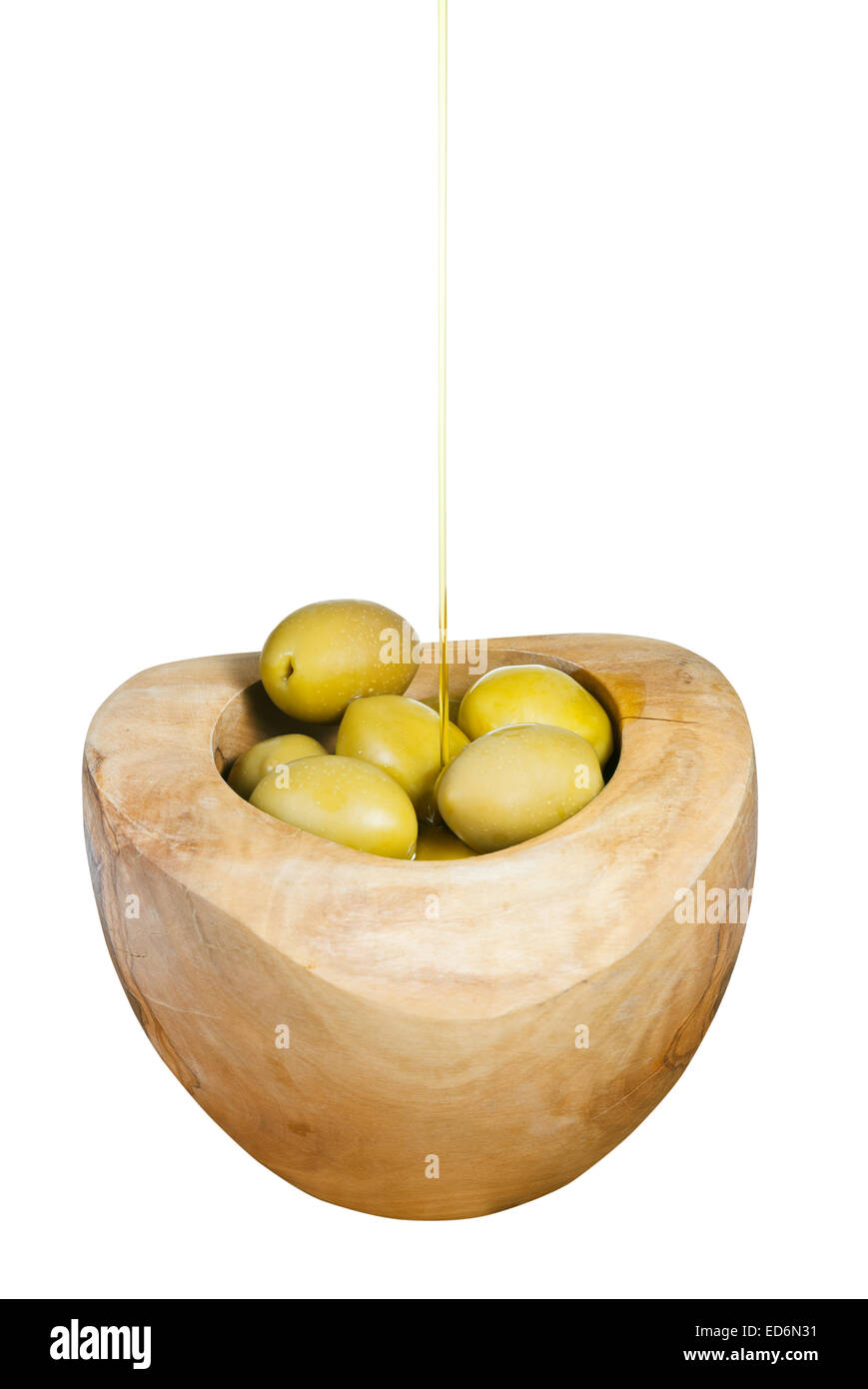 olive oil trickles on green olives in wooden bowl close up isolated on ...