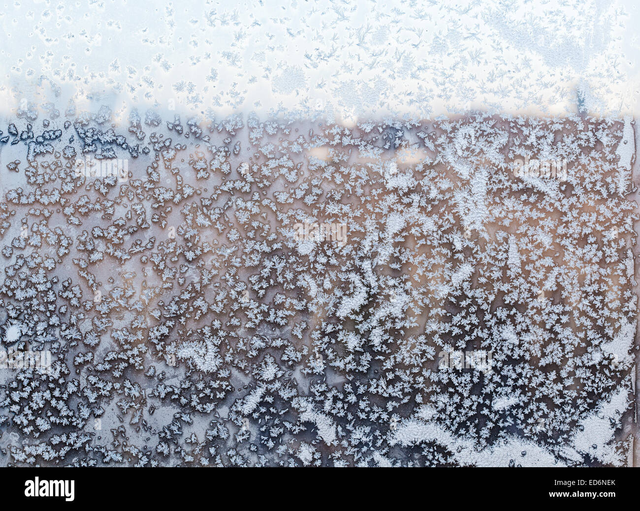 view of urban park through the snow-covered window in cold winter day ...