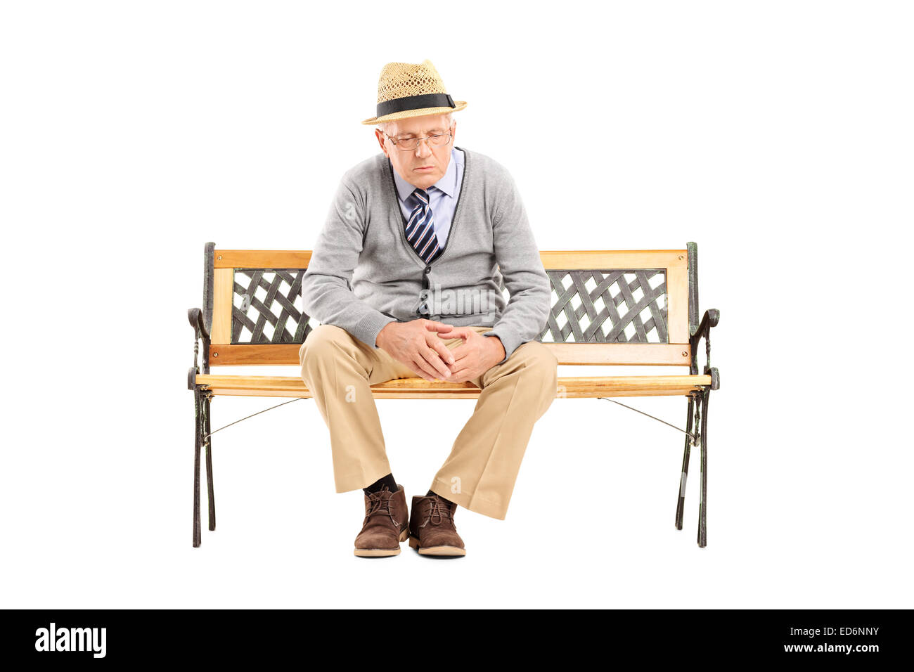 Sad senior thinking seated on a bench isolated on white background ...