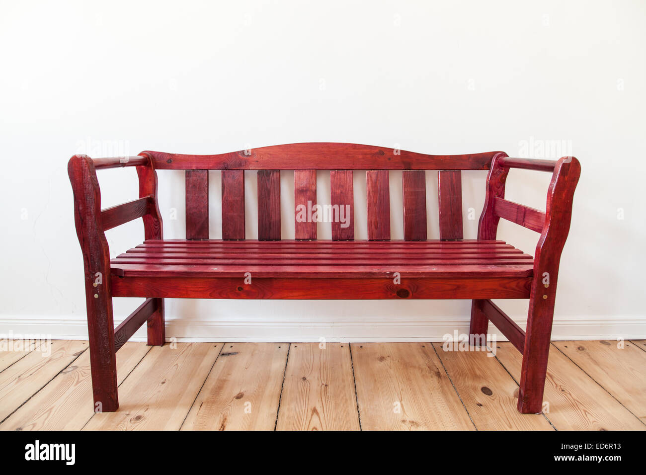 red bench in a room with wooden floor Stock Photo - Alamy