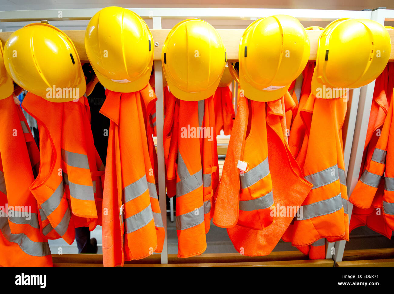 Helmets and hi-vis vests hang in a cloakroom on the grounds of the coal ...
