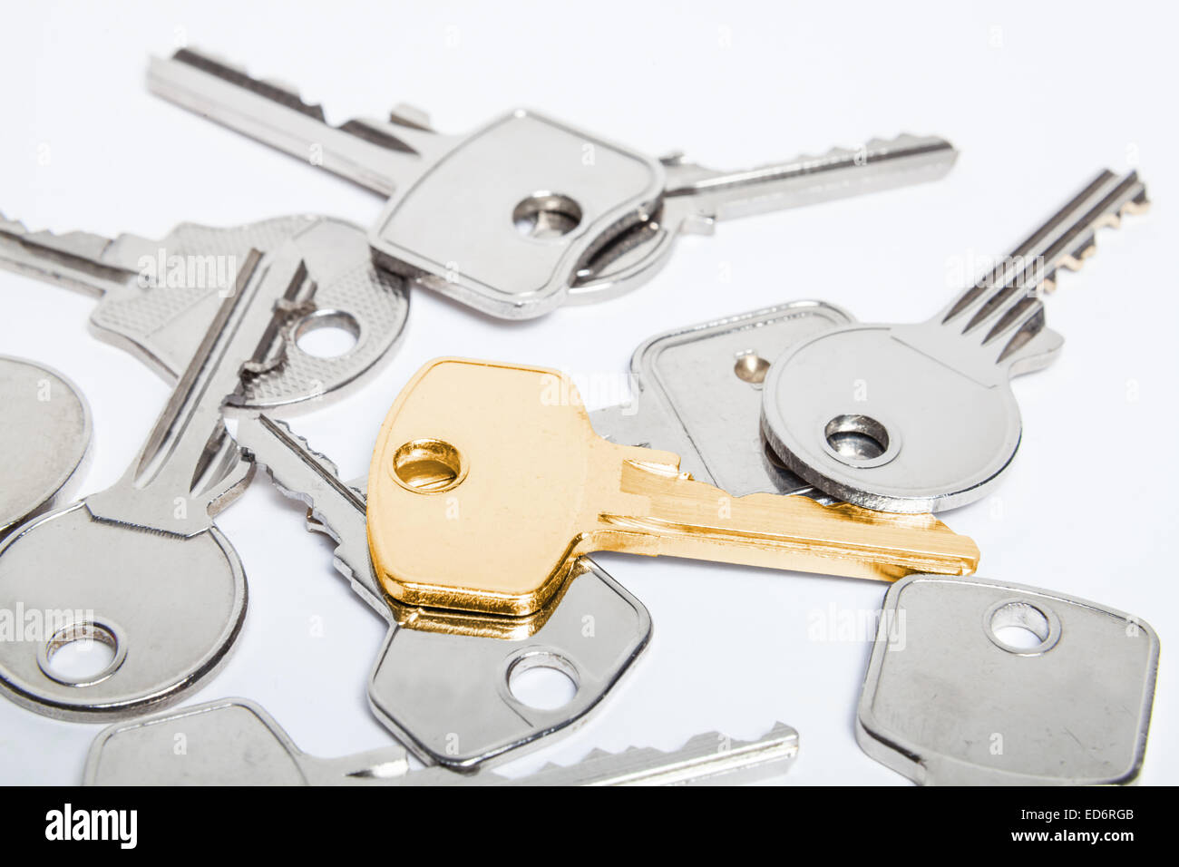 golden key on a pile of keys Stock Photo - Alamy