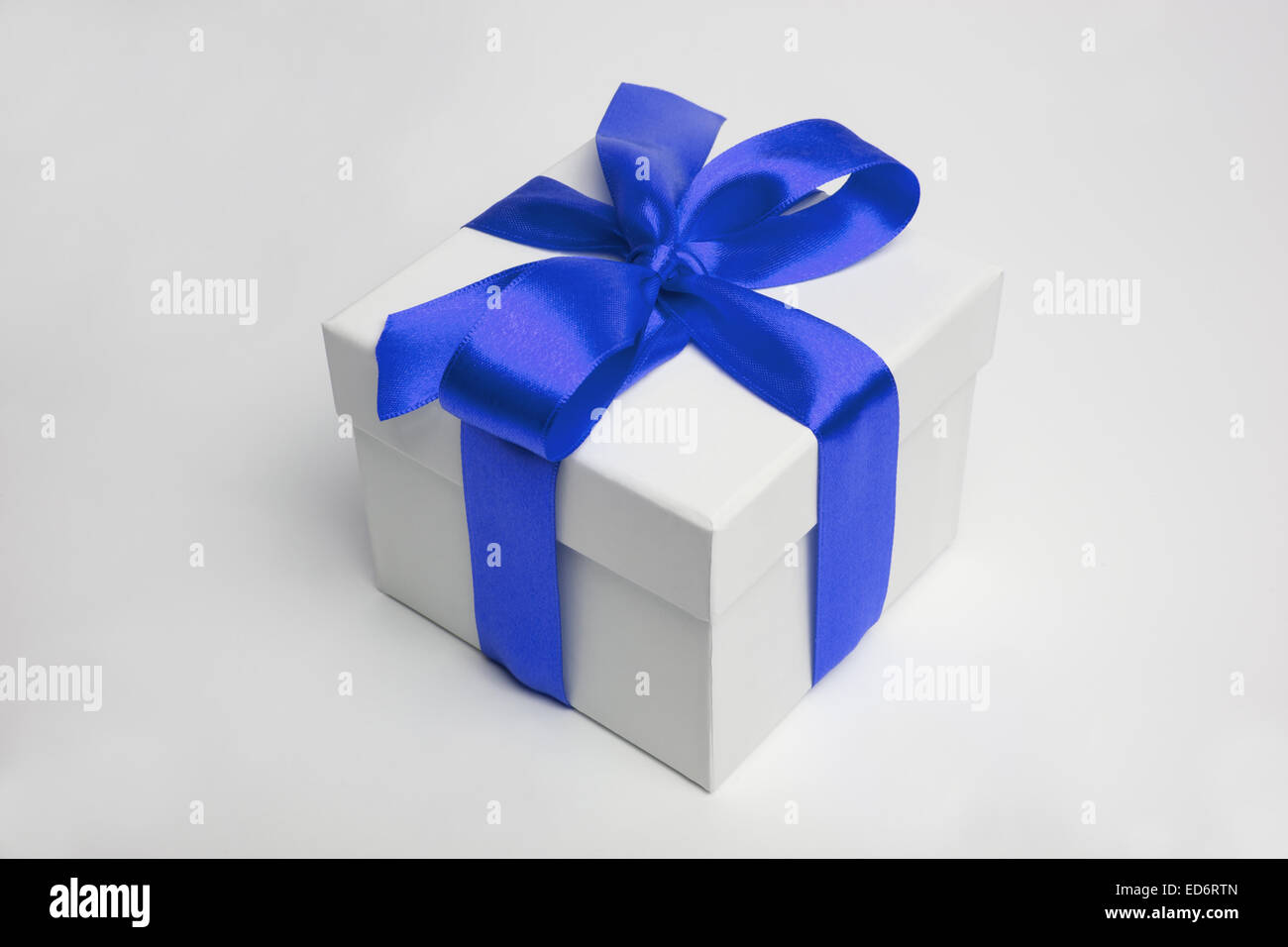 white gift box and blue ribbon Stock Photo - Alamy