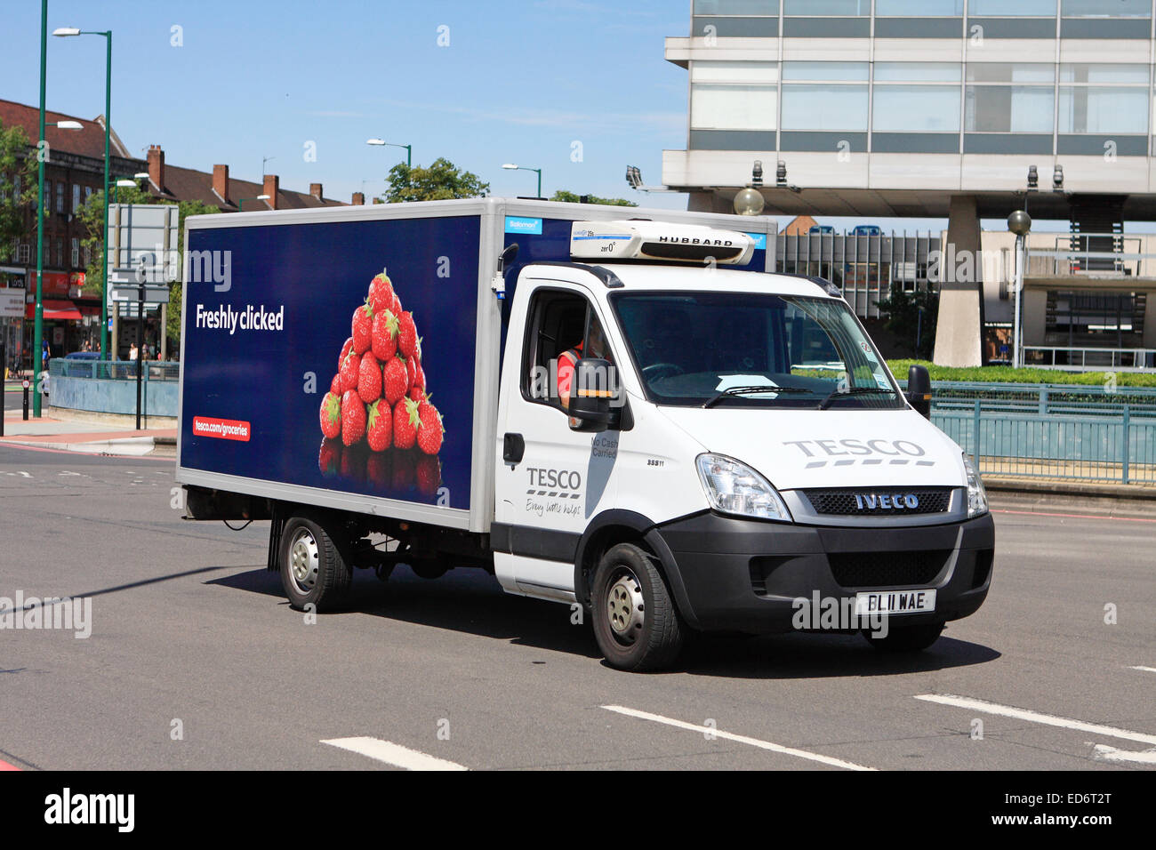 A Tesco truck traveling around a roundabout at Tolworth, Surrey ...