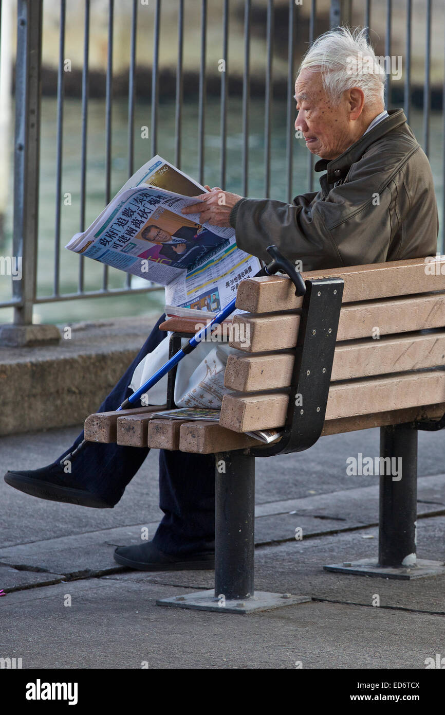 Elderly Chinese Man Reads The Morning Paper On The North Point ...