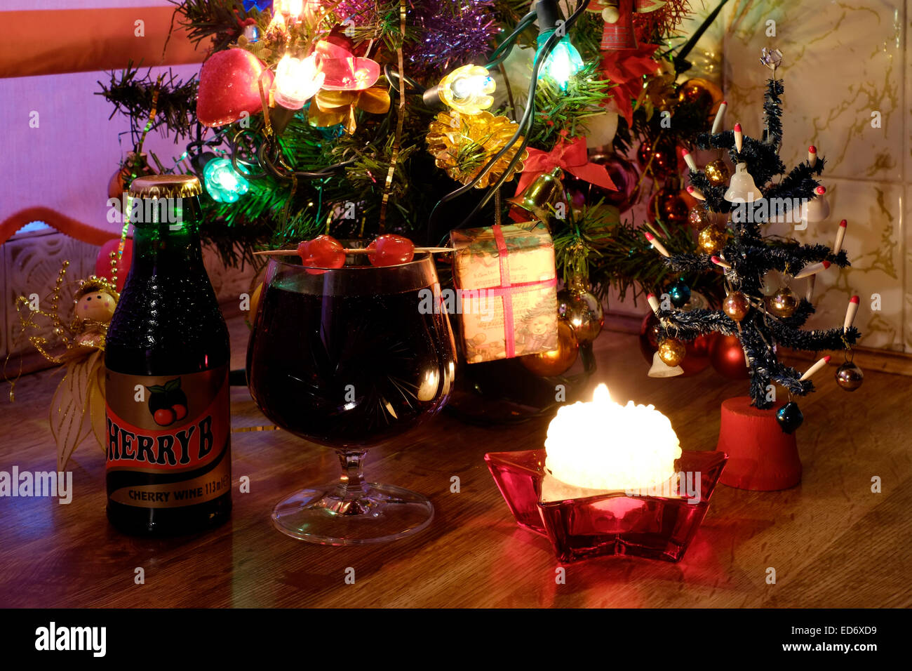 traditional christmas drink cherry b red wine in front of small tree ...