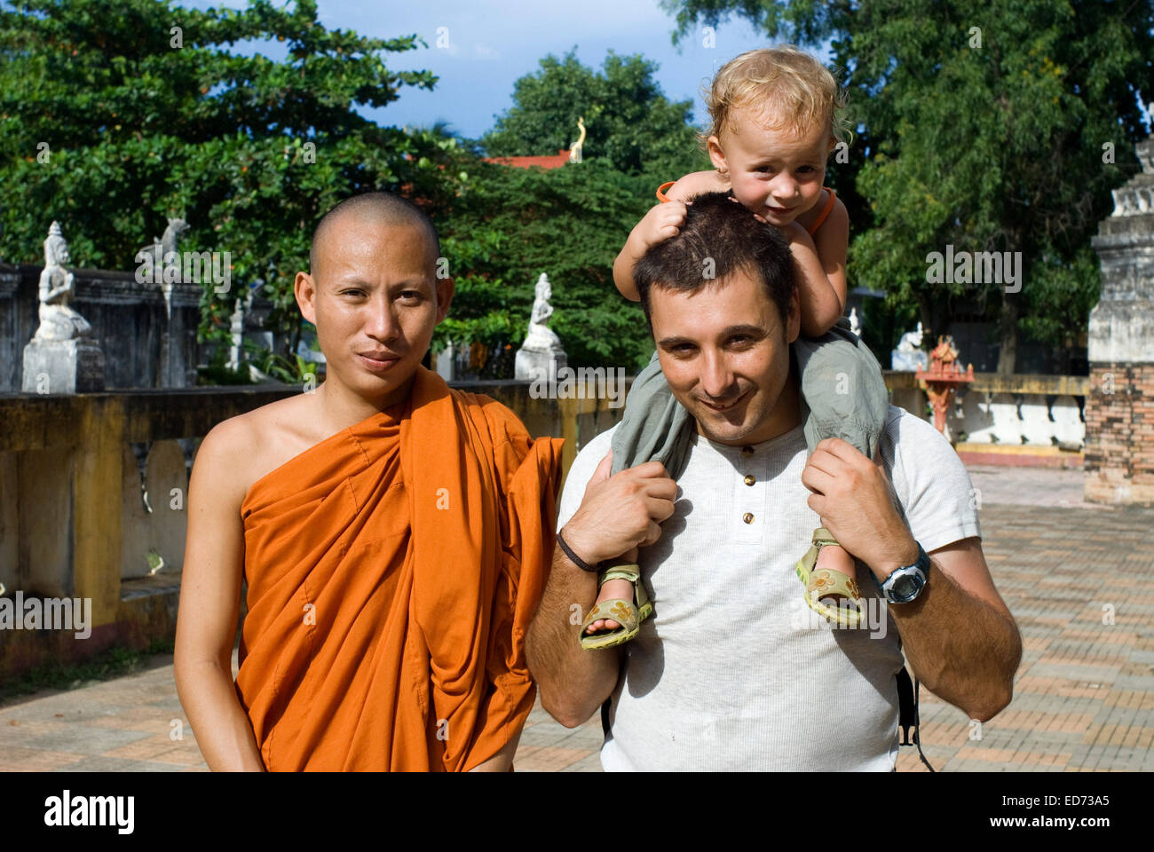 Family with a monk in a Buddhist temple Wat Kandal Battambang. Cambodia ...