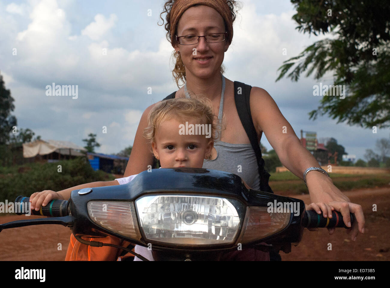 Travel with children’s. Mother riding a motorbike with her daughter ...