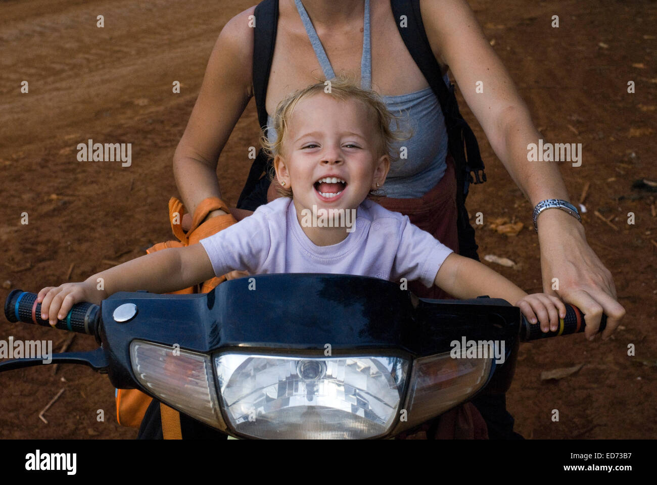 Travel with children’s. Mother riding a motorbike with her daughter ...