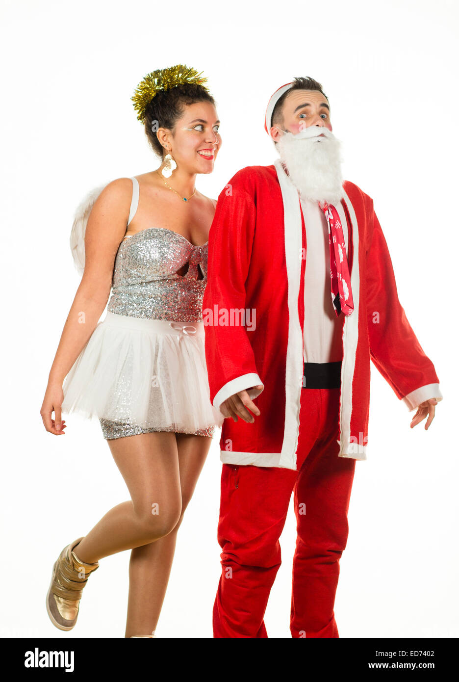 Christmas angel goosing Santa Claus: two young people at a Christmas ...