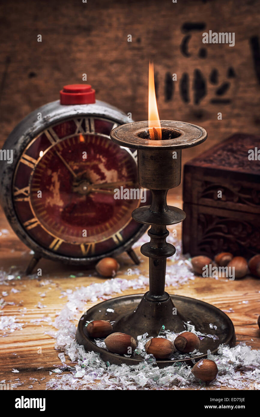 set foto burning Christmas candle in brass candlesticks Stock Photo - Alamy