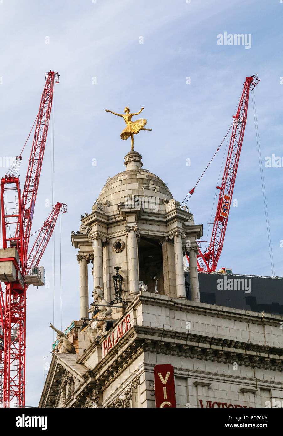 Cranes above the roof of the Victoria Palace theatre in London. The gilded statue of Anna ...