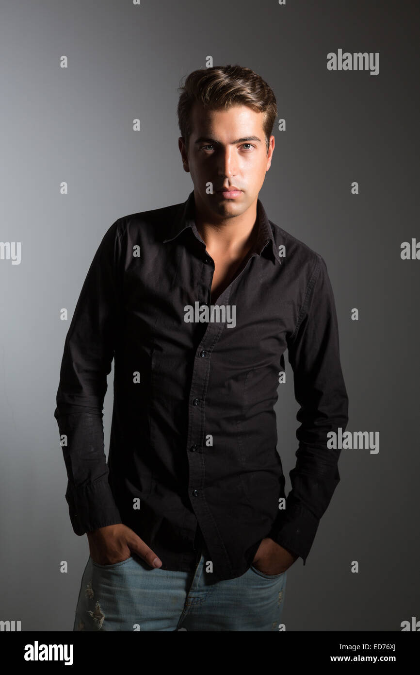 Studio picture of a young and handsome man posing isolated Stock Photo ...