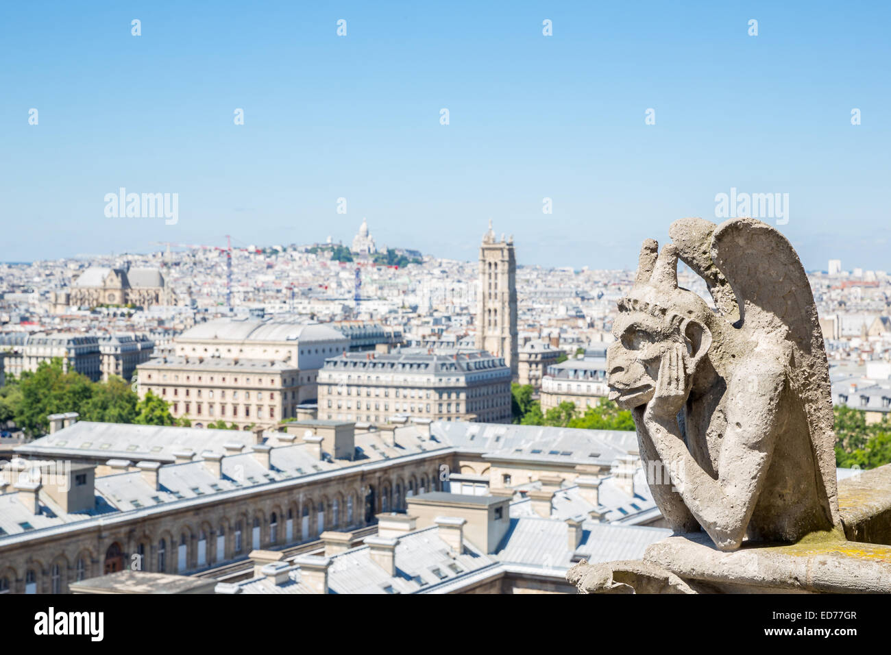 Gargoyle Stryge and demon at Notre Dame of Paris overlooking the ...