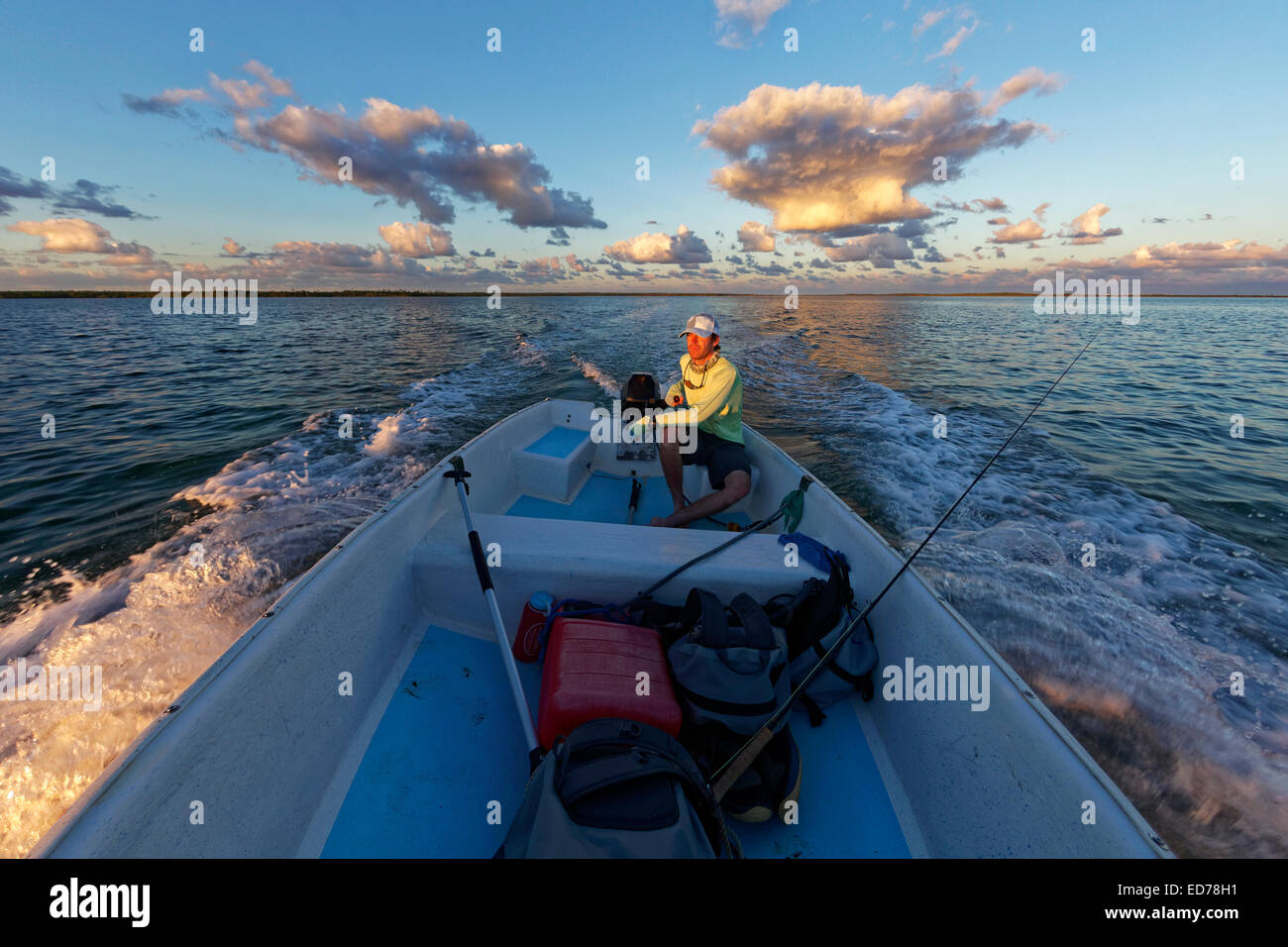 Fisherman driving small boat at sunset, abaco, bahamas Stock Photo - Alamy