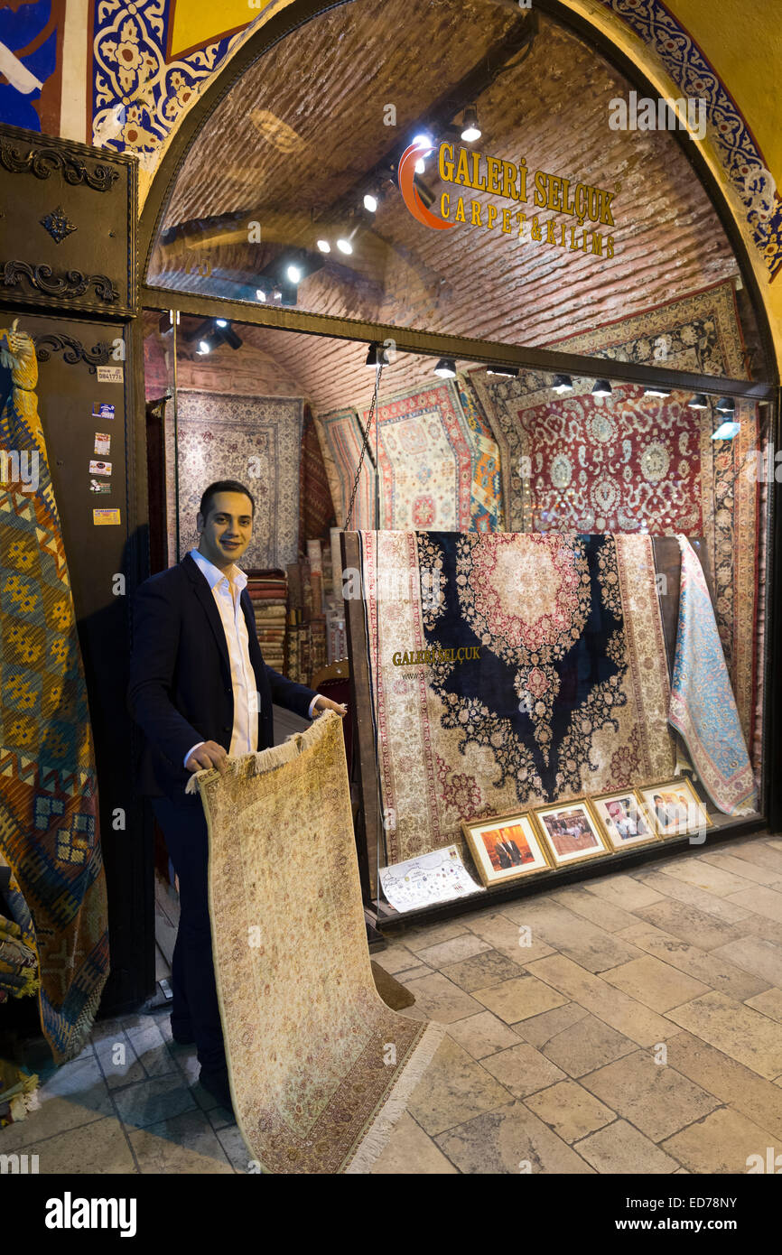 Salesman with traditional Turkish carpet rug in The Grand Bazaar ...