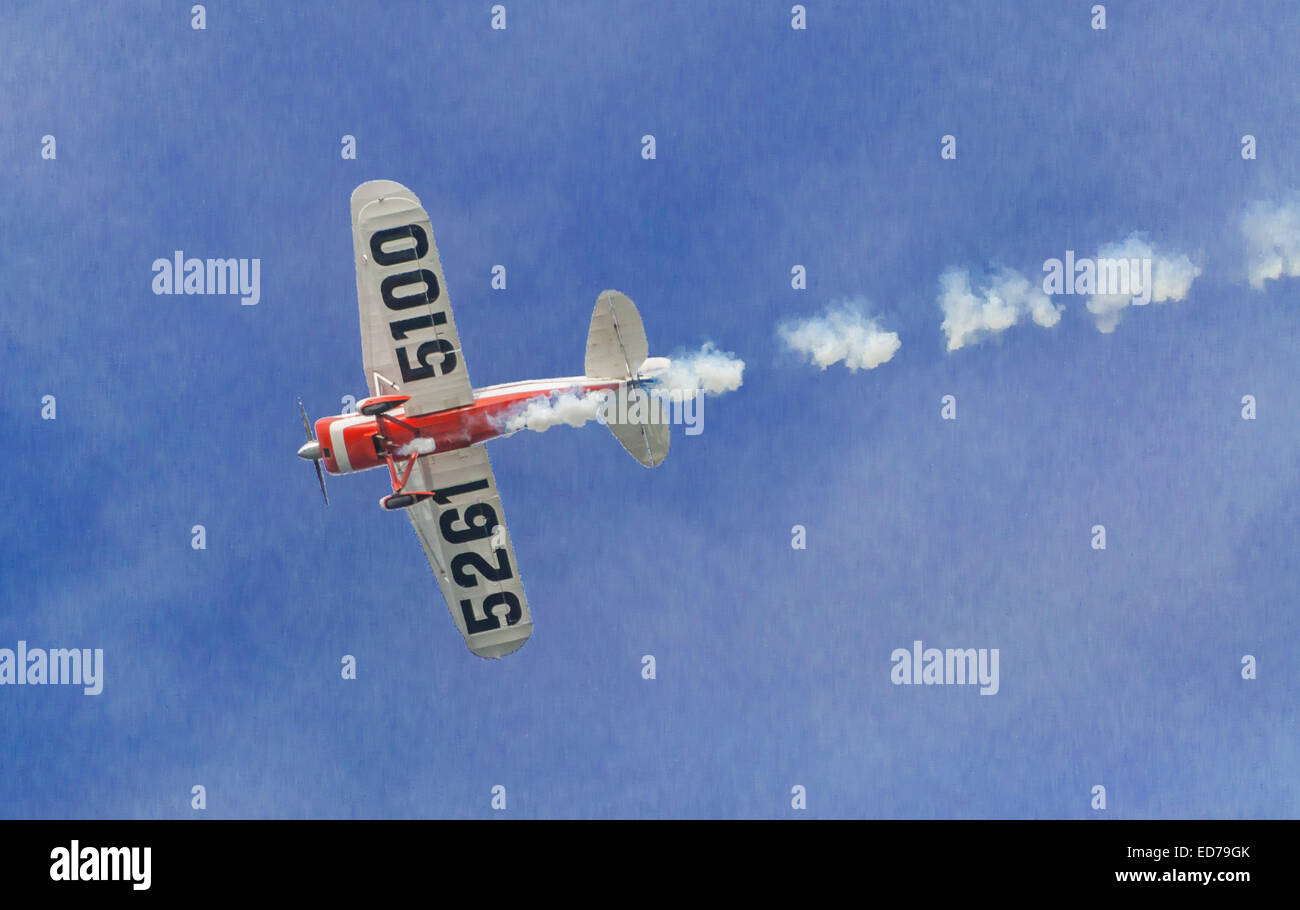bi plane in sky with emission skywriter Stock Photo - Alamy